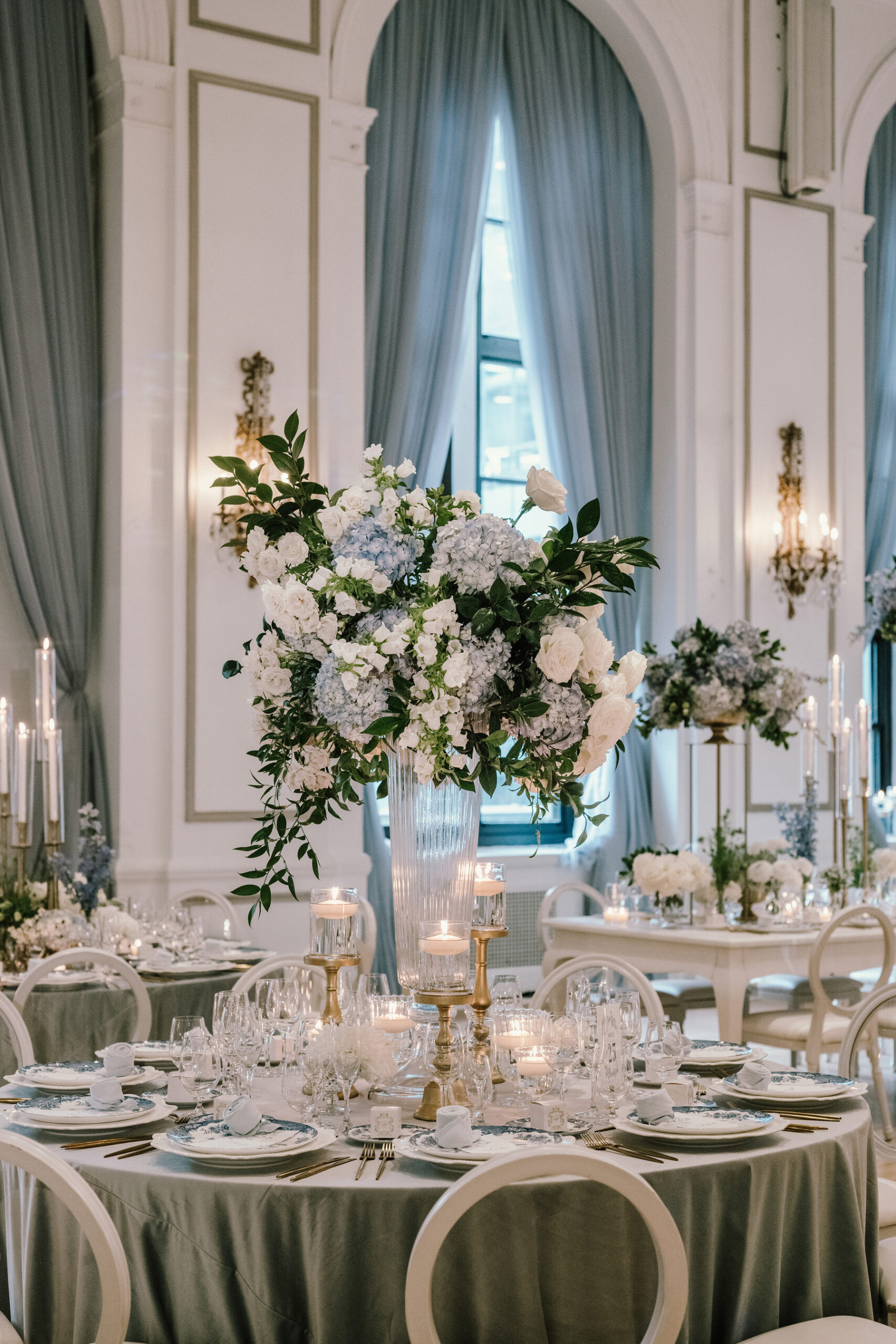 An elegant banquet hall in Fresh Rococo Style features round tables ...
