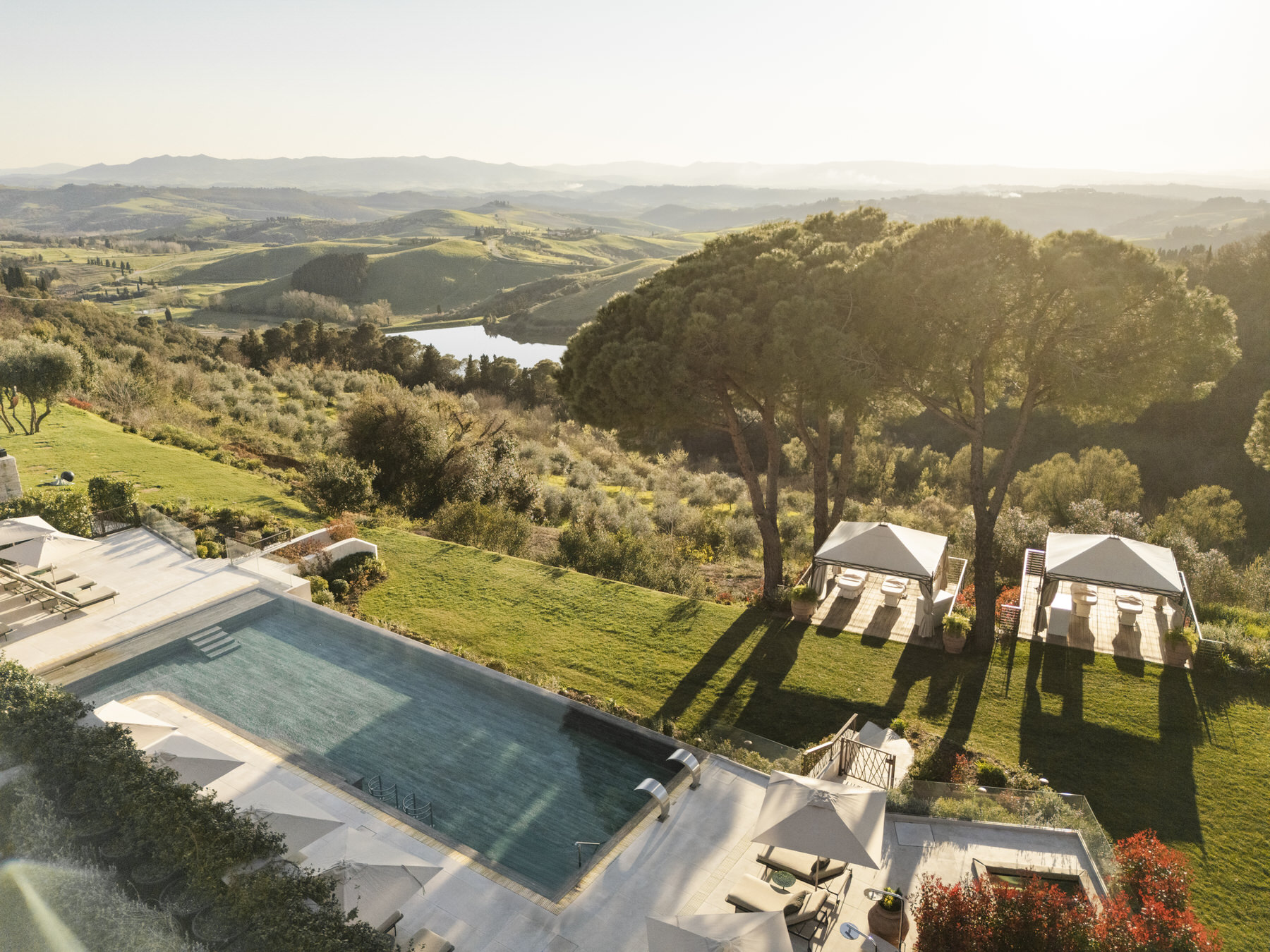 Aerial view of a luxurious outdoor pool and lounge area with cabanas at ...