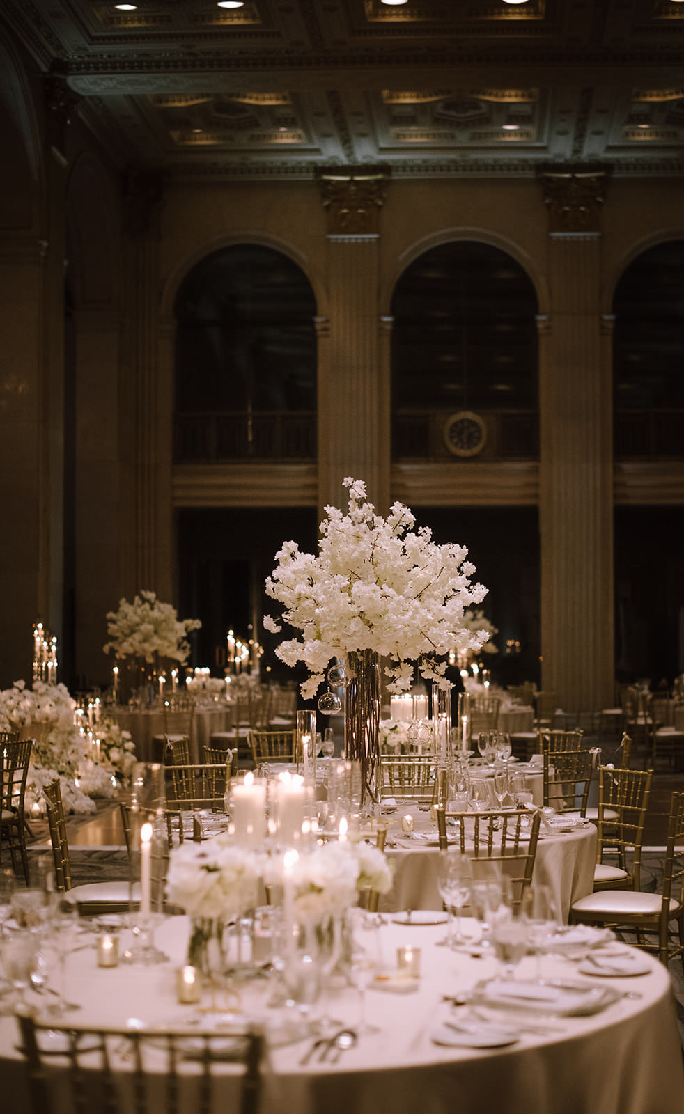 Elegant banquet hall at One King West with round tables set for a ...