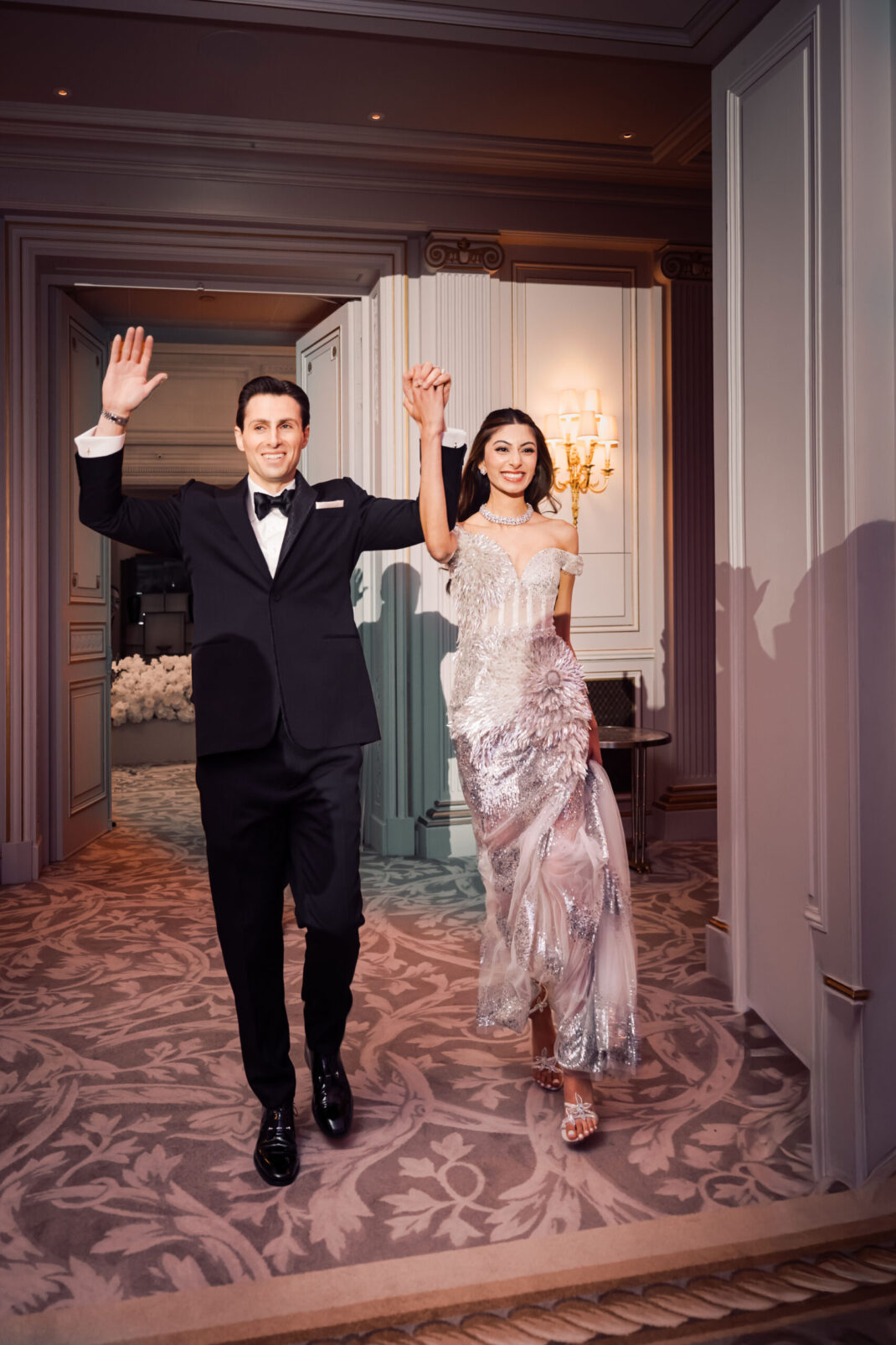 A smiling couple in formal attire, the man in a black tuxedo and the ...