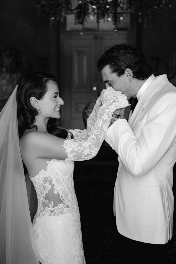 A bride and groom face each other, smiling, at their elegant Portugal ...
