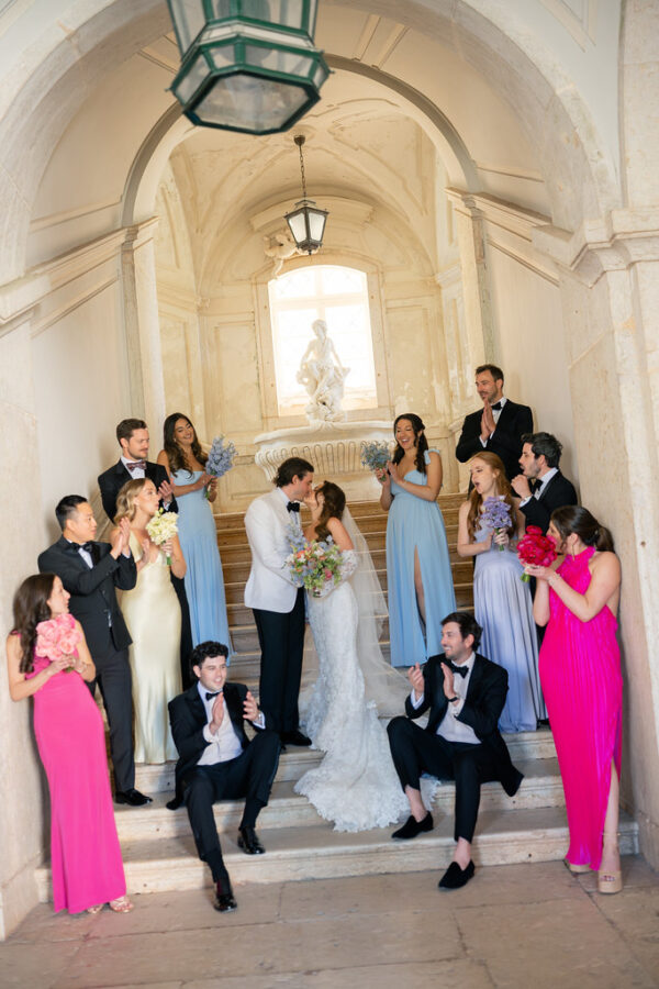 A bride and groom kiss on marble stairs at their Portugal destination ...