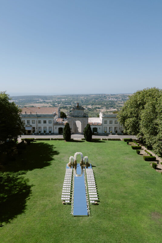 A large, elegant lawn set for a Portugal palace wedding features rows ...